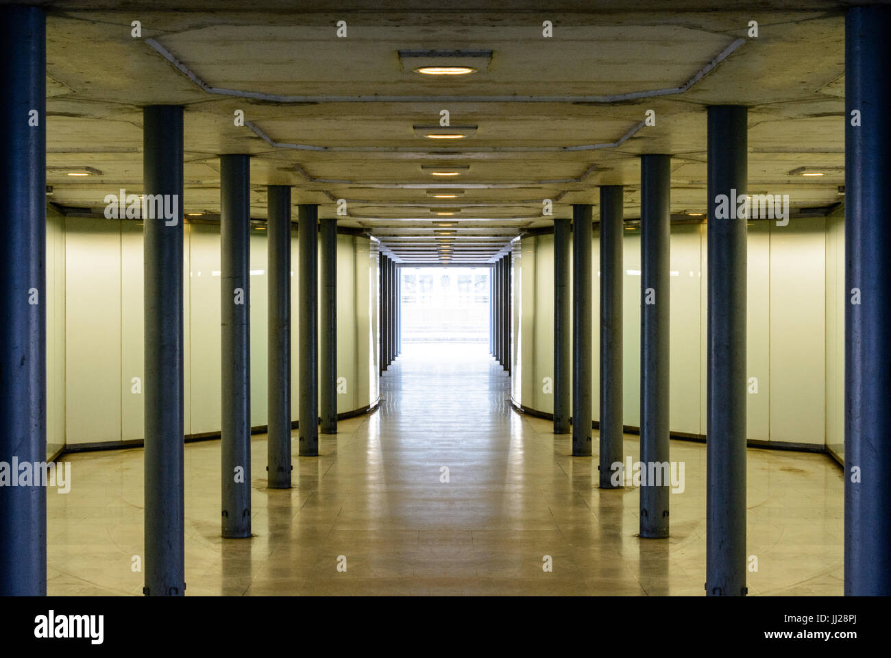 Underground pedestrian passage with alignments of metallic pillars ...