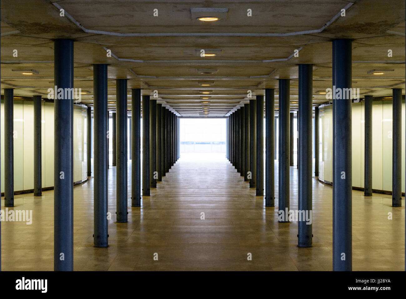 Underground pedestrian passage with alignments of metallic pillars ...