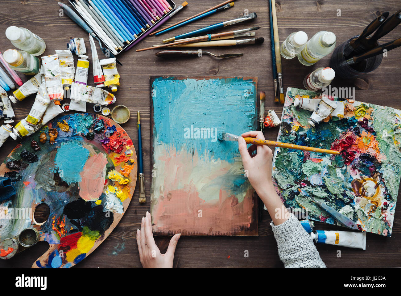 Painter workplace top view photo. Artist paintbrushes, colorful paints ...