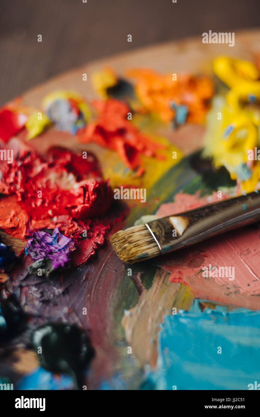 color palette with fresh paint and brush on wood table Stock Photo - Alamy