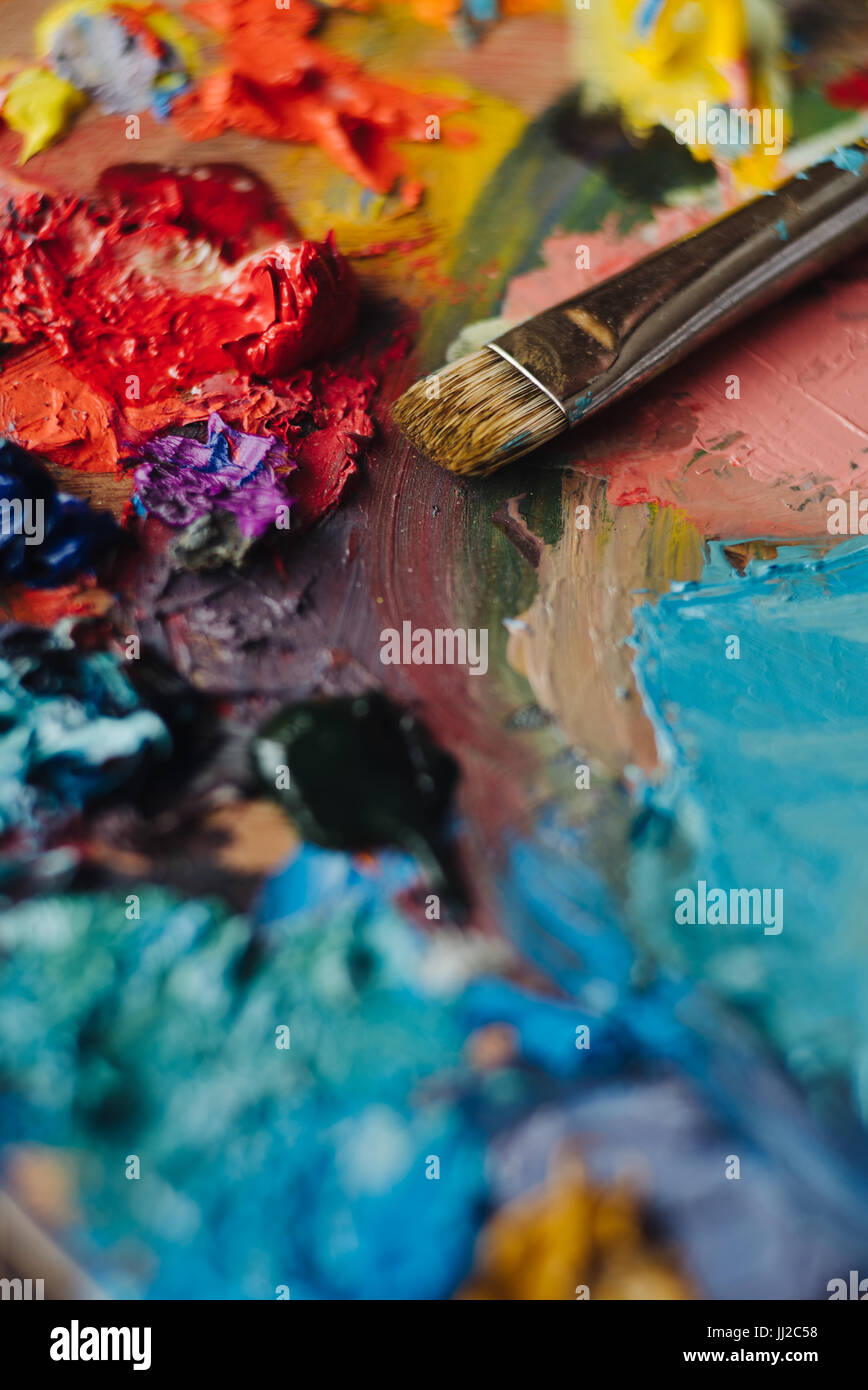 color palette with fresh paint and brush on wood table Stock Photo - Alamy