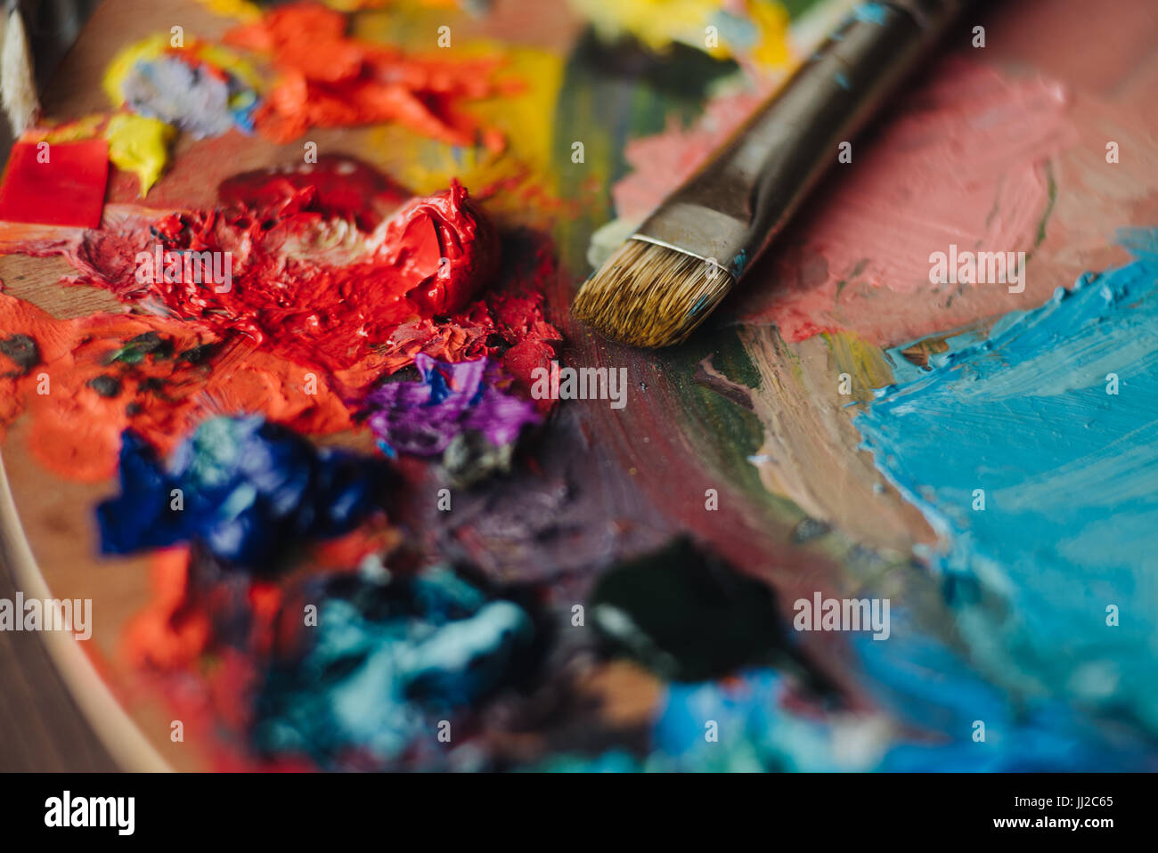 color palette with fresh paint and brush on wood table Stock Photo - Alamy