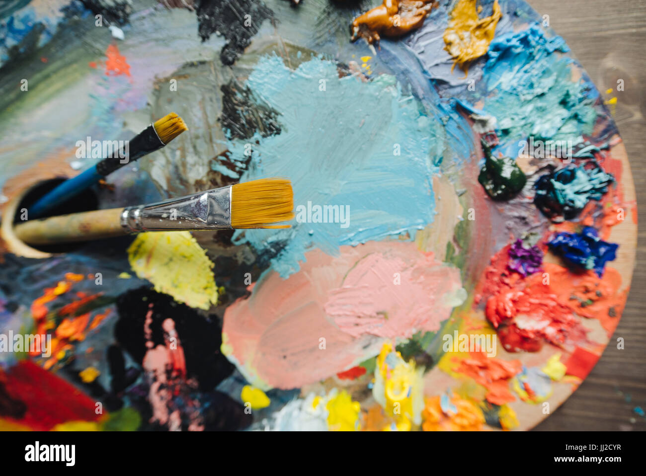 color palette with fresh paint and brush on wood table Stock Photo - Alamy