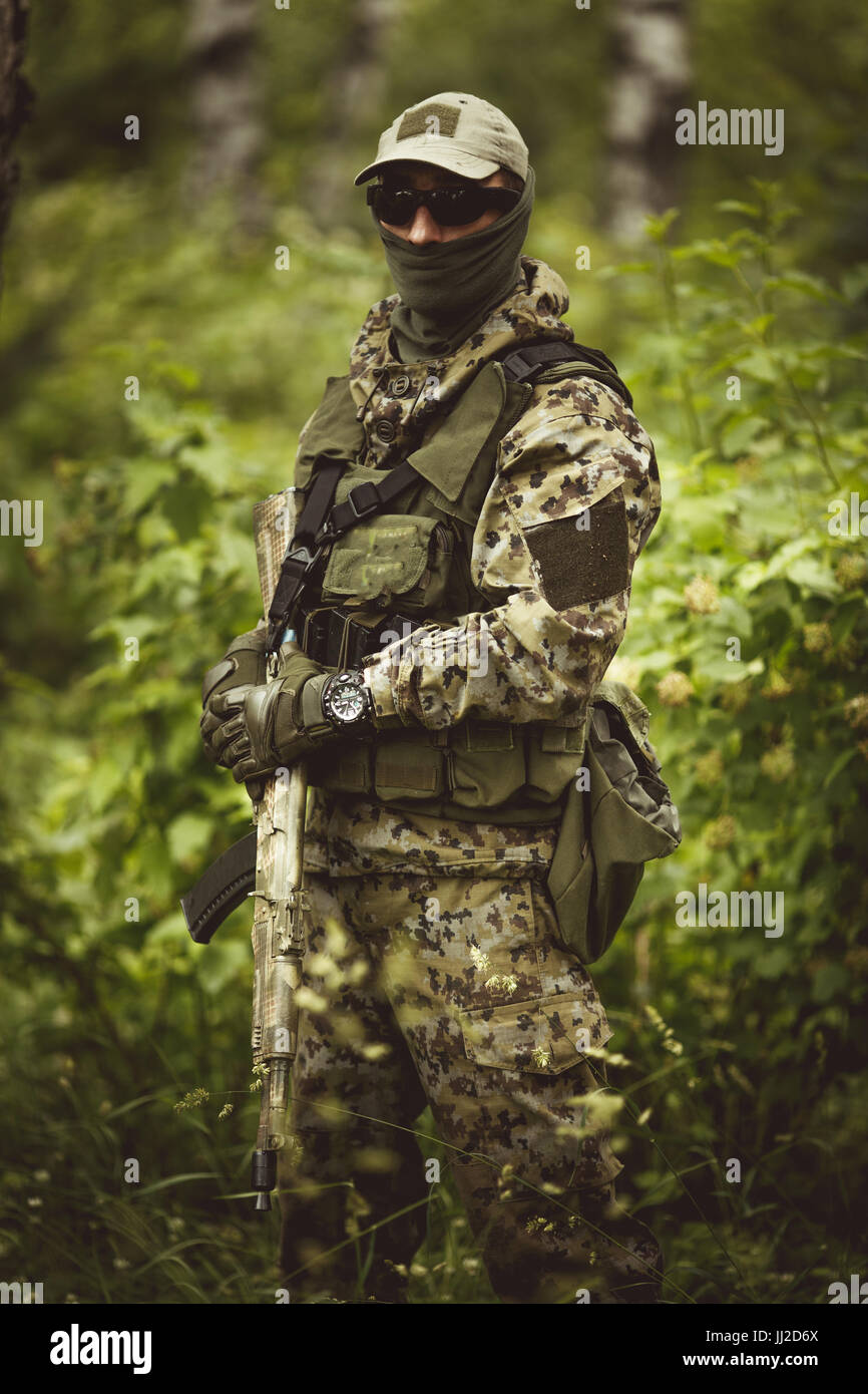 Military man in camouflage , helmet Stock Photo - Alamy