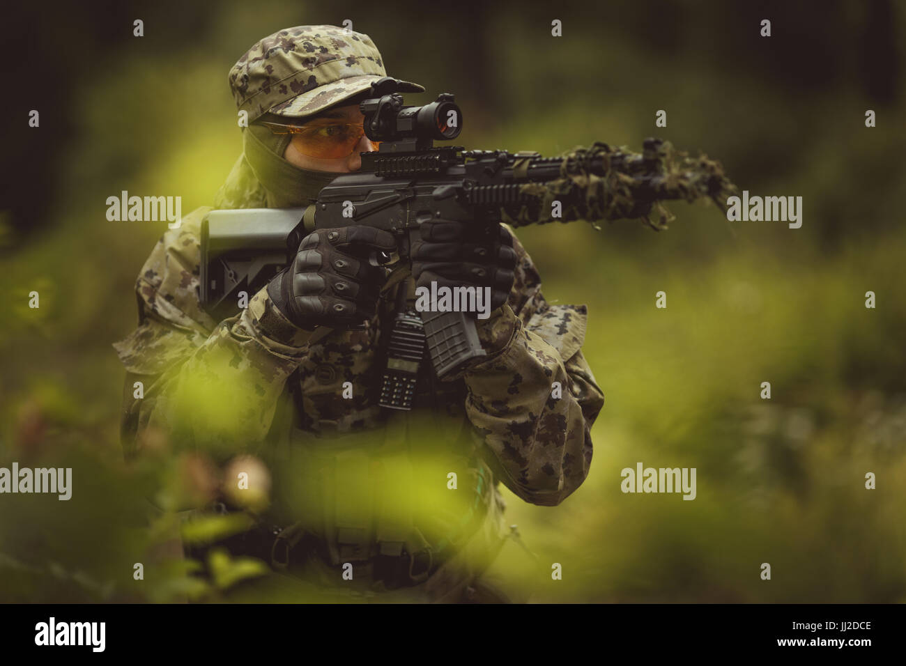 Strikeball player aiming in forest Stock Photo - Alamy