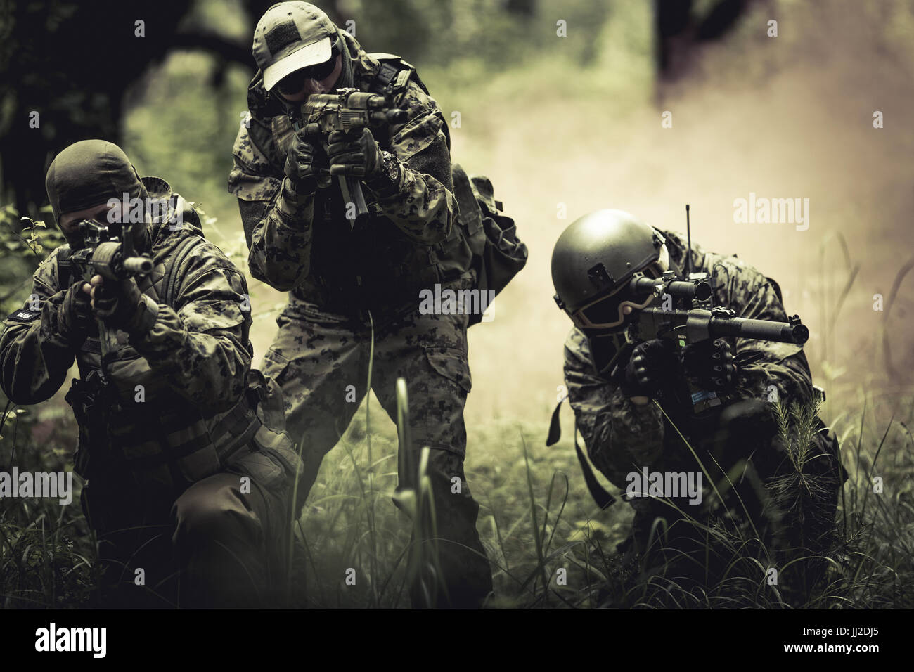 Strikeball players in helmets, guns Stock Photo - Alamy