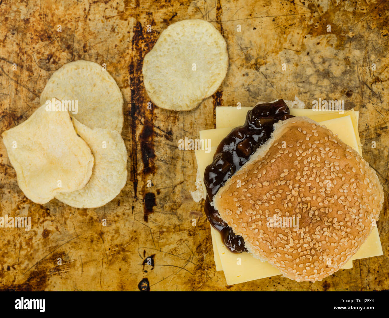 Cheese and Pickle Sesame Bread Roll With Potato Crisps On A Distressed ...