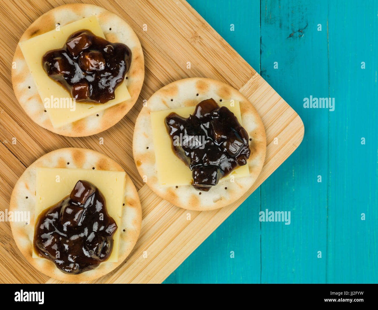 Cheese and Pickle on Biscuit Crackers On A Chopping Board Against a ...