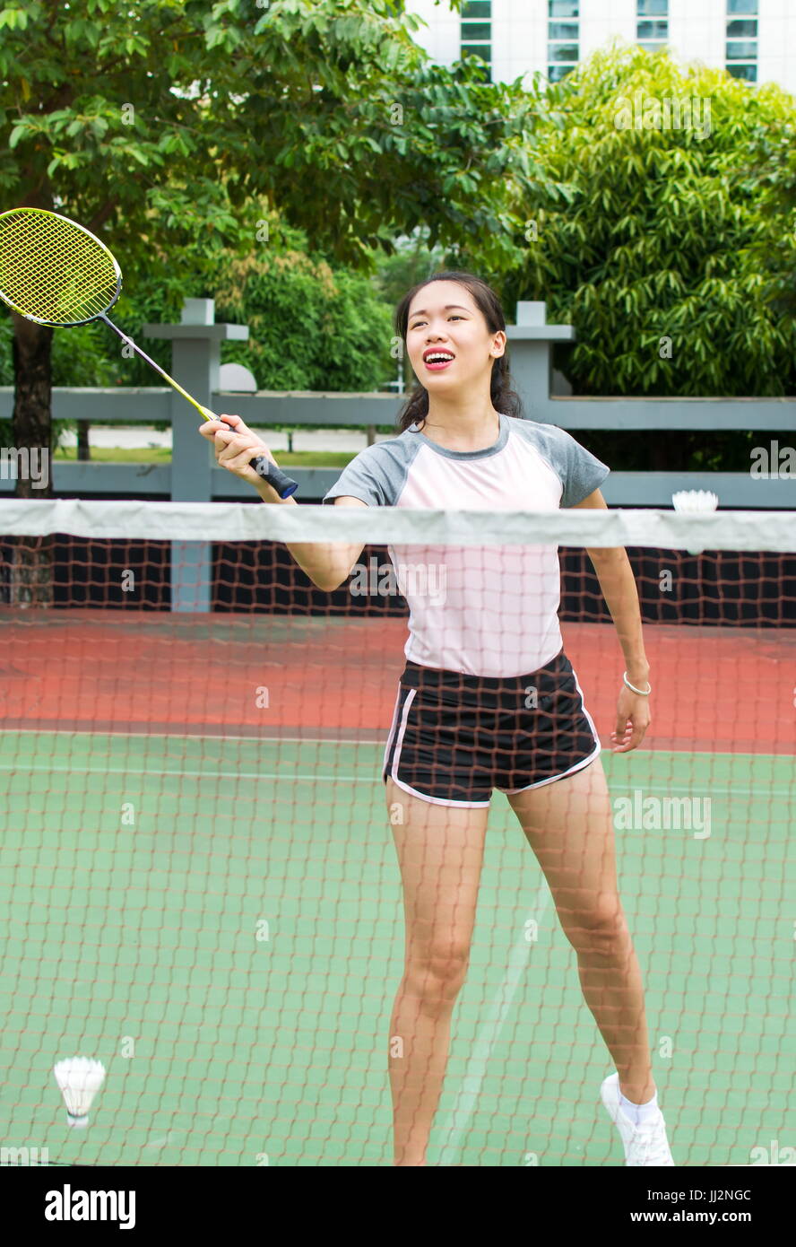Asian girl playing badminton on the outdoors court Stock Photo - Alamy