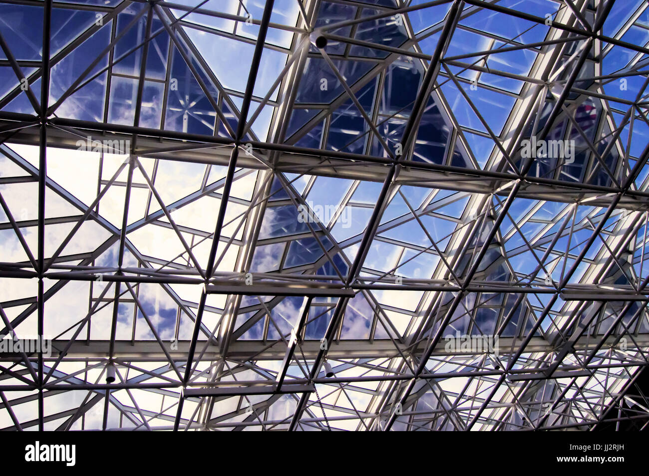 A glass and steel strut roof with sun shining through it Stock Photo ...