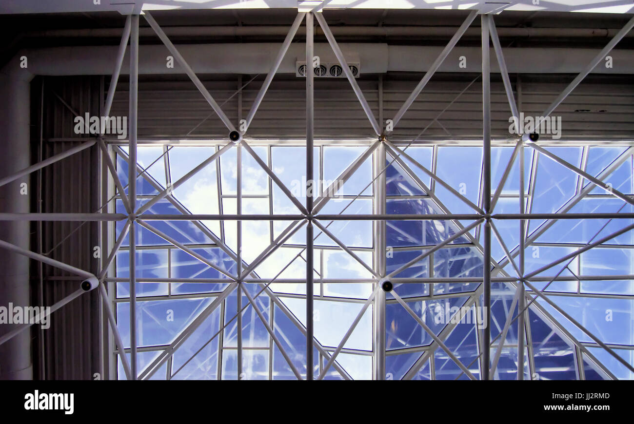 A glass and steel strut roof with sun shining through it Stock Photo ...