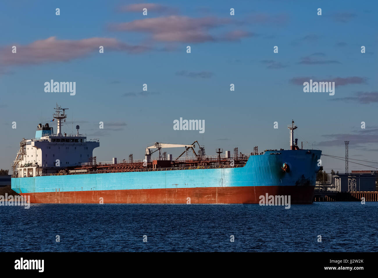 Blue cargo ship loading in the port of Riga, Europe Stock Photo - Alamy