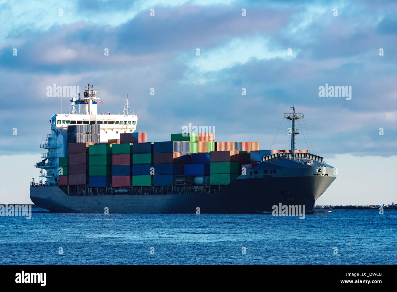 Modern grey container ship moving in still water Stock Photo - Alamy