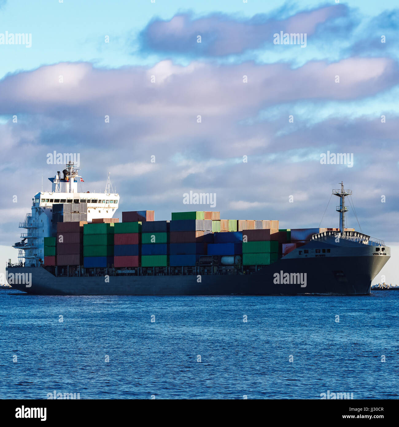 Modern grey container ship moving in still water Stock Photo - Alamy