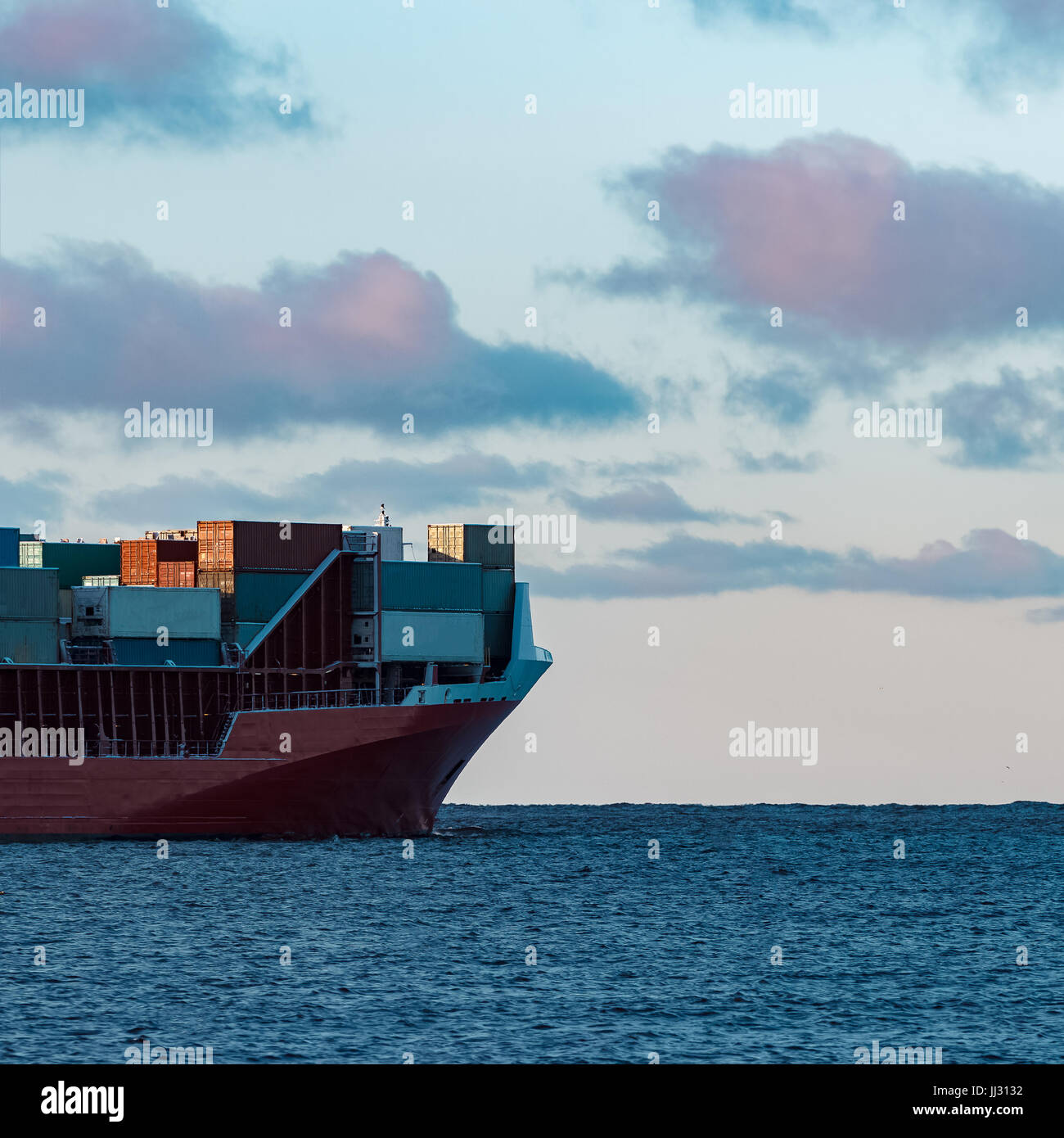 Full red container ship moving in still water Stock Photo - Alamy