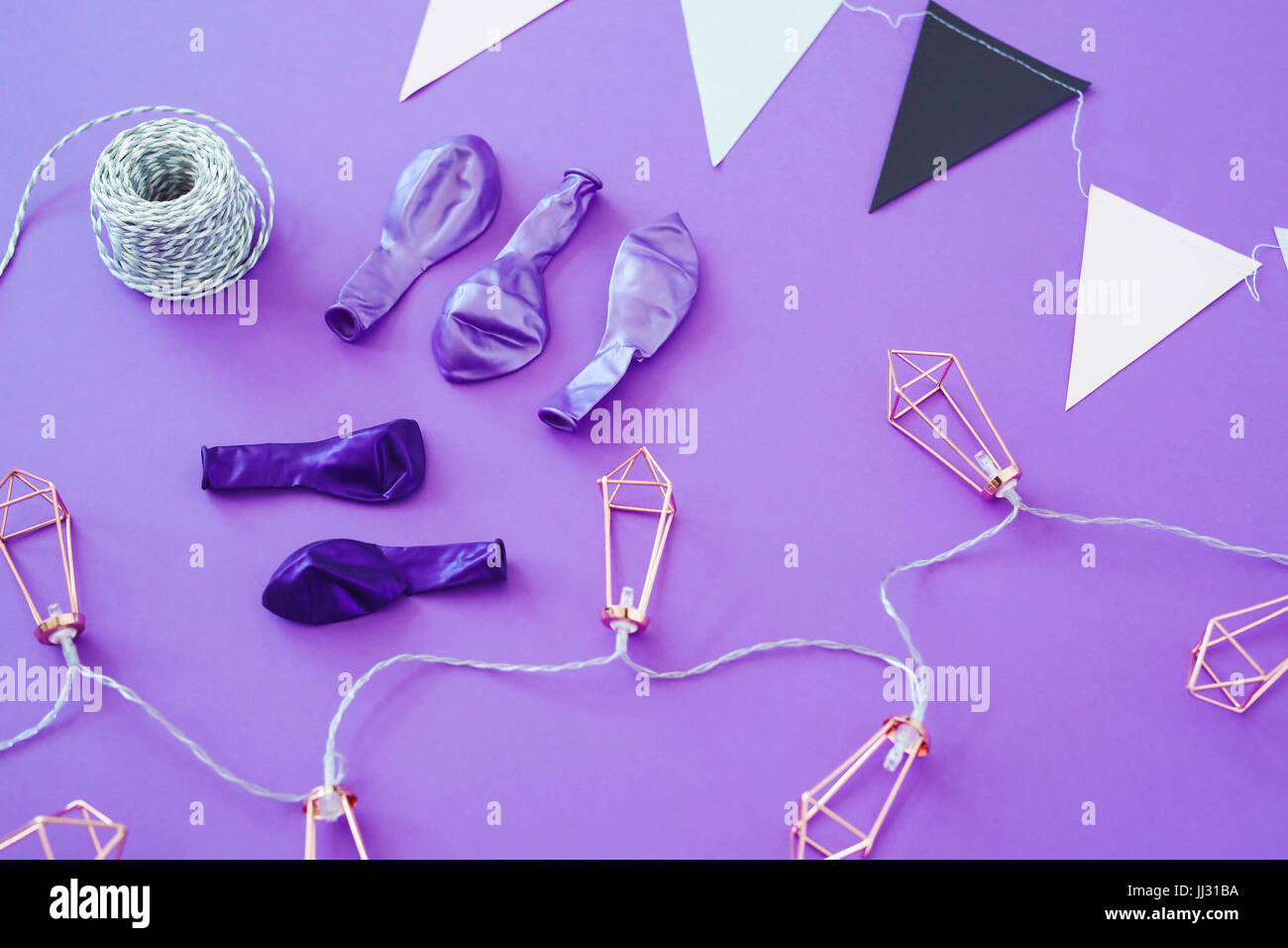Festive. Party objects on a purple background Stock Photo - Alamy