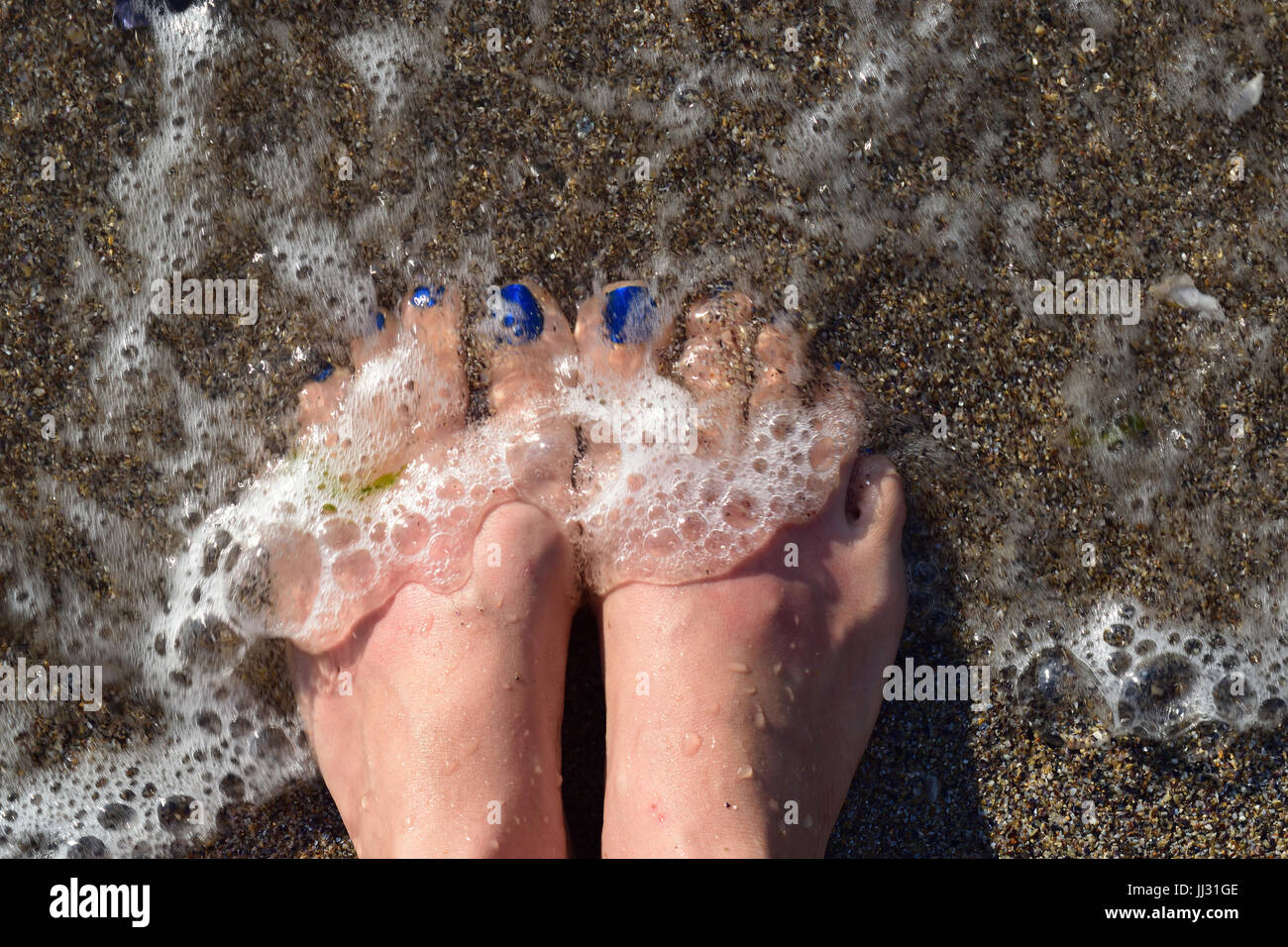 Feet in the sea water Stock Photo - Alamy
