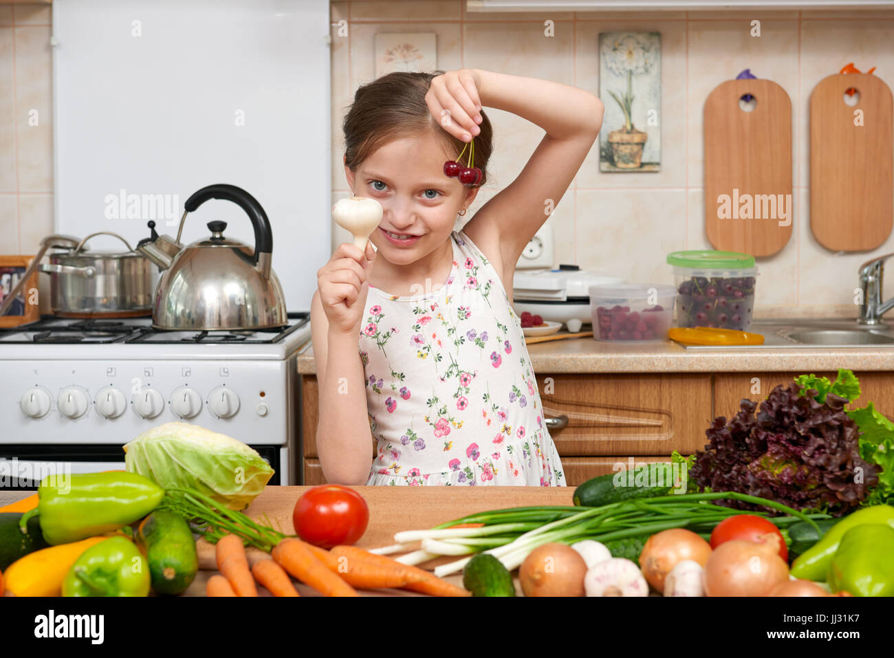 child girl with fruits and vegetables in home kitchen interior, healthy ...