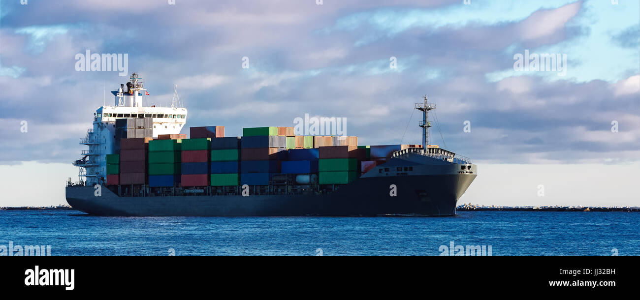 Modern grey container ship moving in still water Stock Photo - Alamy