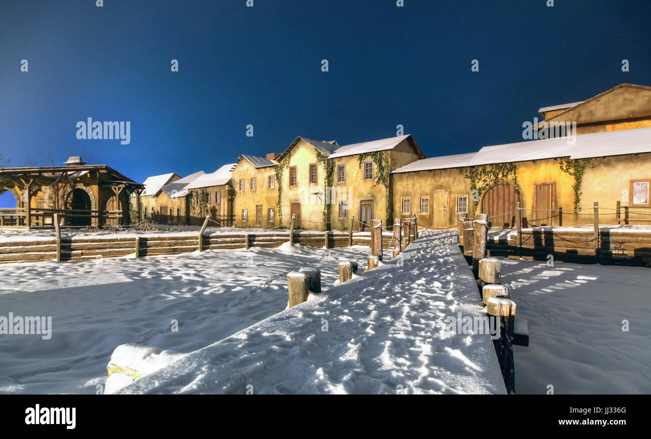 Snow covered wooden pier of the medieval town at night Stock Photo - Alamy