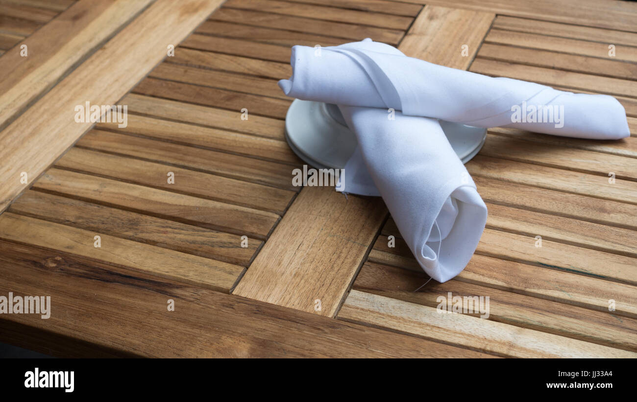 Restaurant table setteing ready for customers, cutlery wrapped in white ...