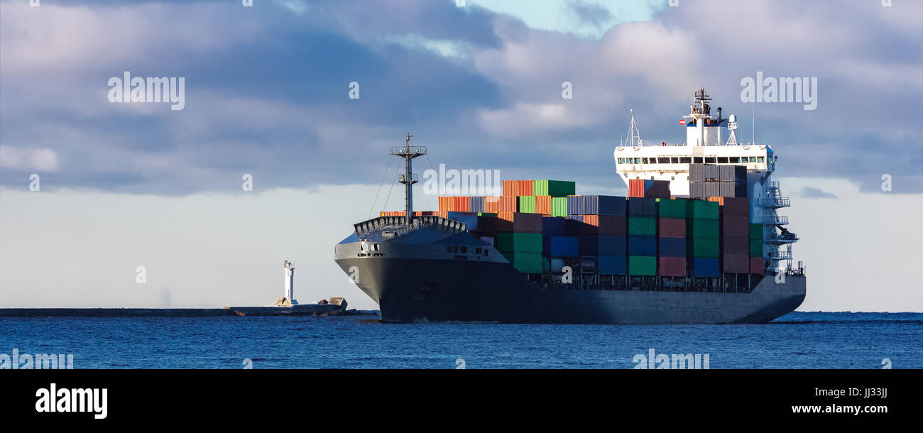 Modern grey container ship moving in still water Stock Photo - Alamy