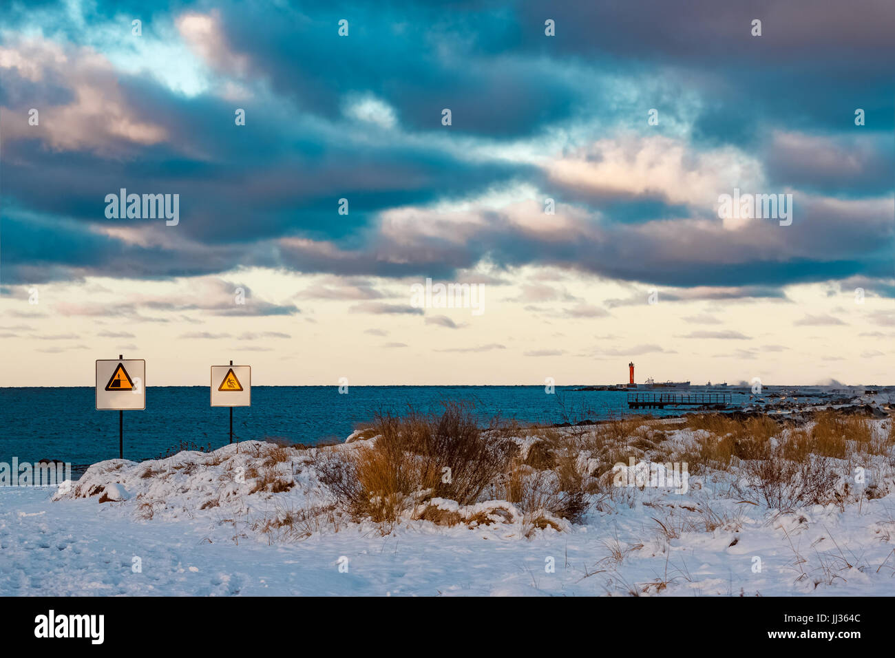 Two yellow warning signs on the winter beach Stock Photo - Alamy