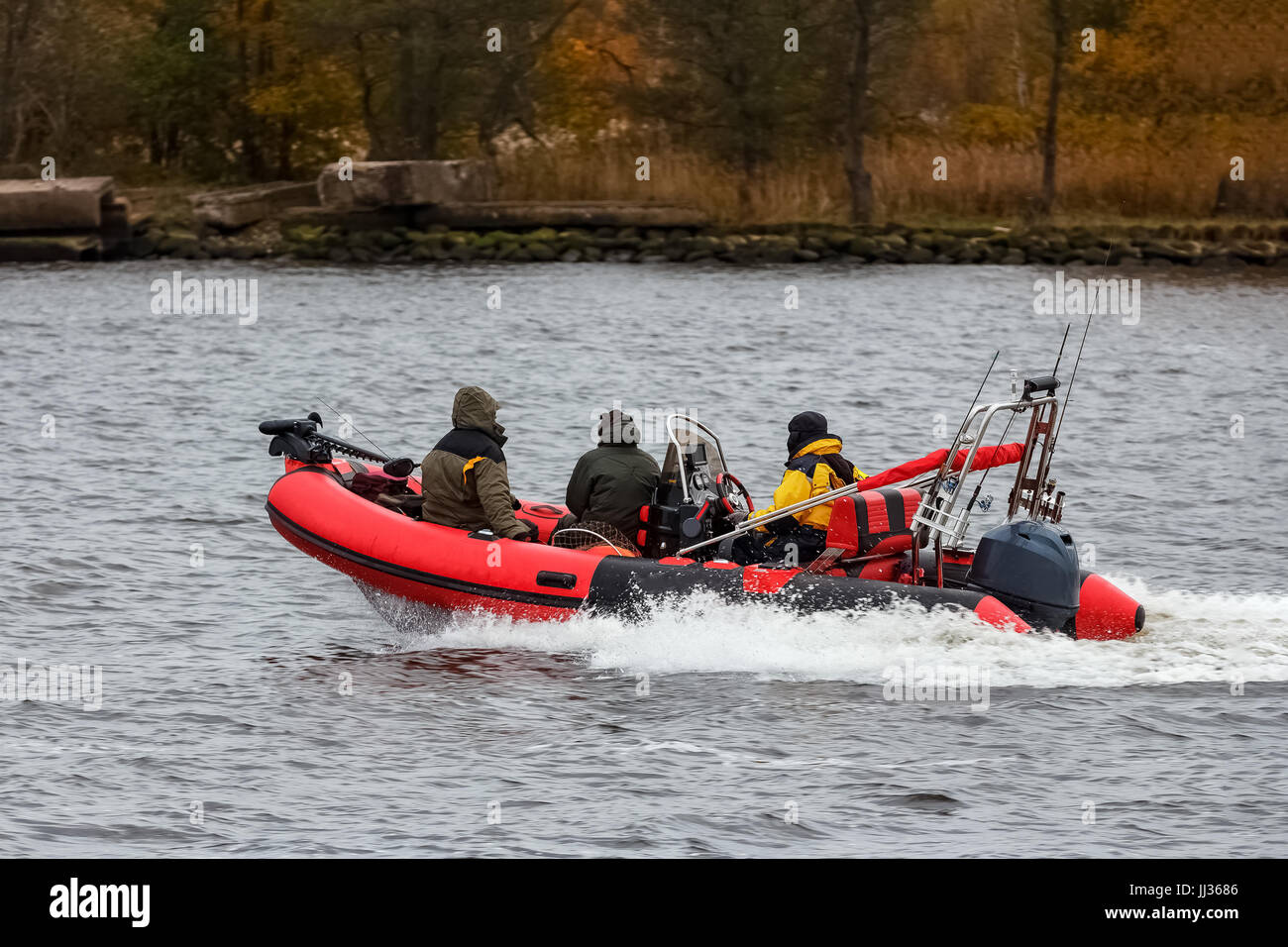 Red inflatable boat with fishermans moving at speed Stock Photo - Alamy
