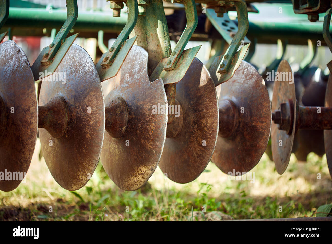 Discs of a harrowing agricultural machinery outdoor with selective ...