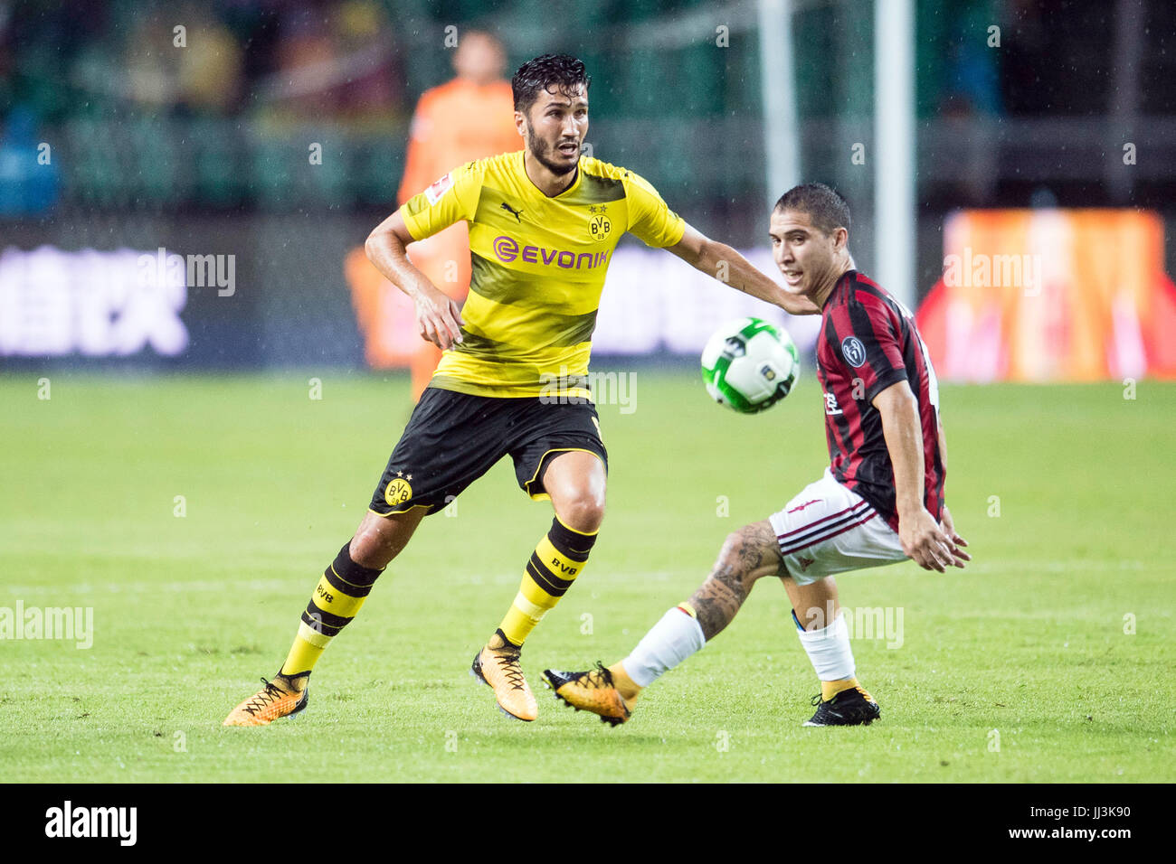 Guangzhou, China. 18th July, 2017. Milan's Jose Mauri (r) and Dortmund ...