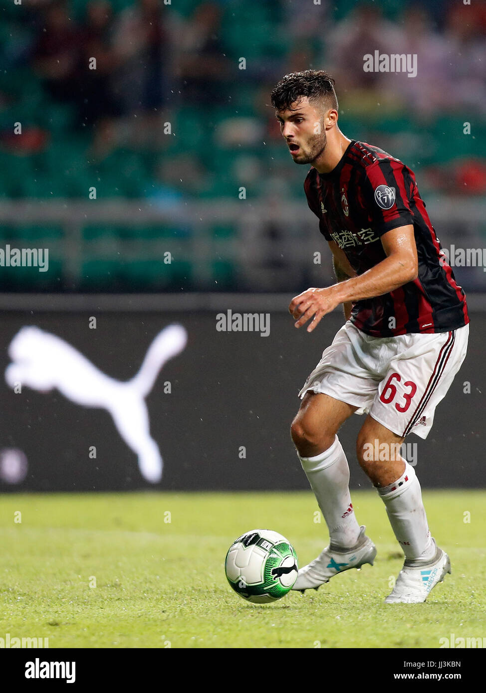 Guangzhou, China. 18th Jul, 2017. Patrick Cutrone of AC Milan controls ...