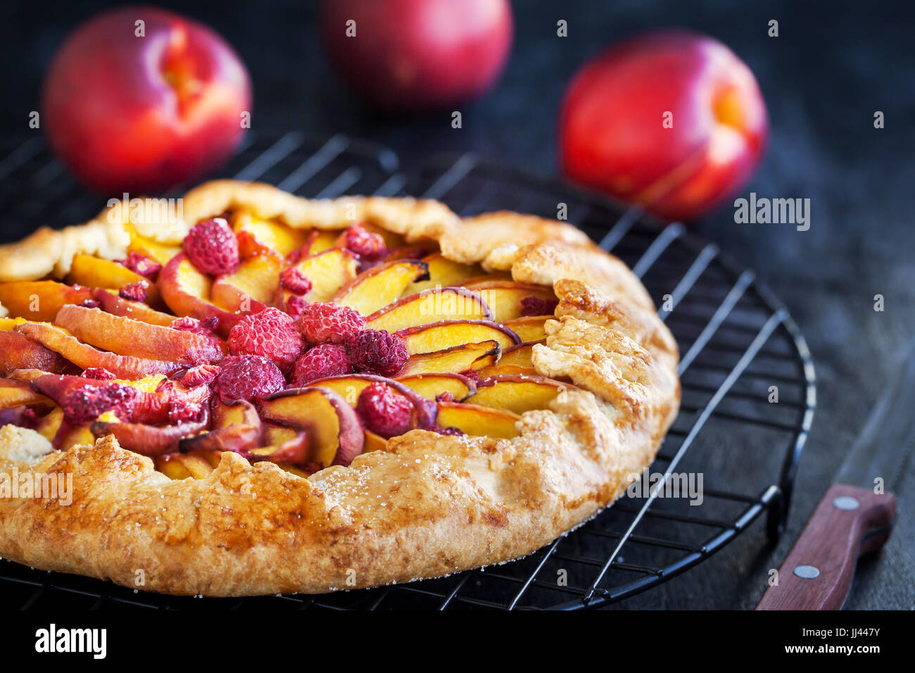 Rustic open pie with peach and raspberry (french galette Stock Photo ...