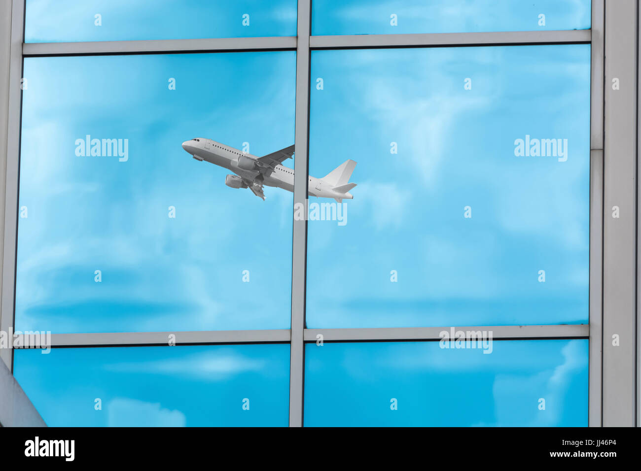 Beautiful glass building facade with reflections of an airplane during ...