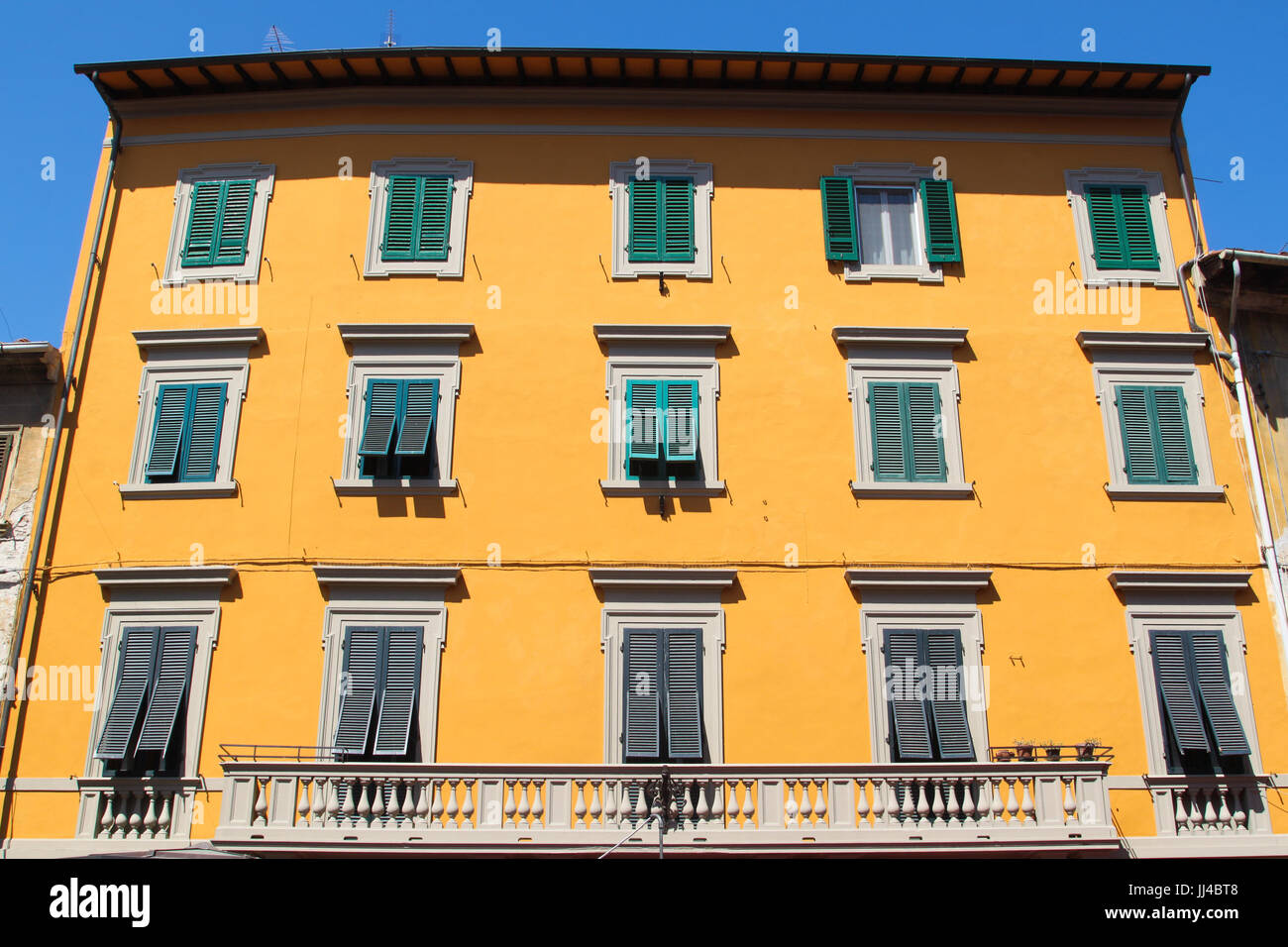 Old orange building with long balcony in Pisa, Italy Stock Photo - Alamy