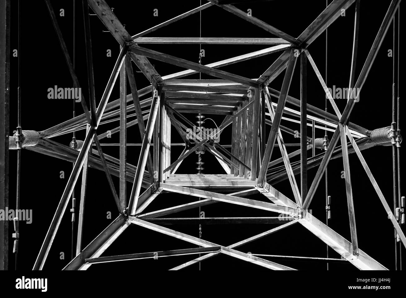 View from underneath a metal electrical tower at night Stock Photo - Alamy