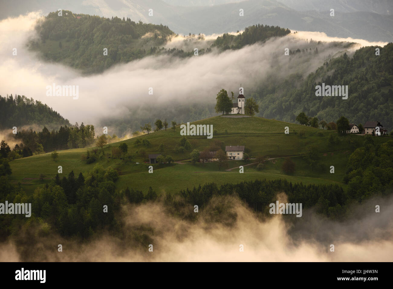 Detail of rolling fog at sunrise in the Skofjelosko Hribovje Hills with ...