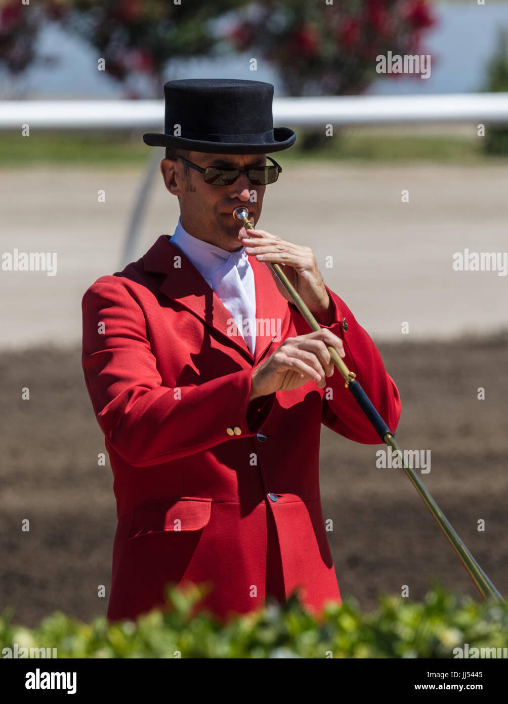 Bugler in top hat and coat plays Cal to the Post at the horse races in ...