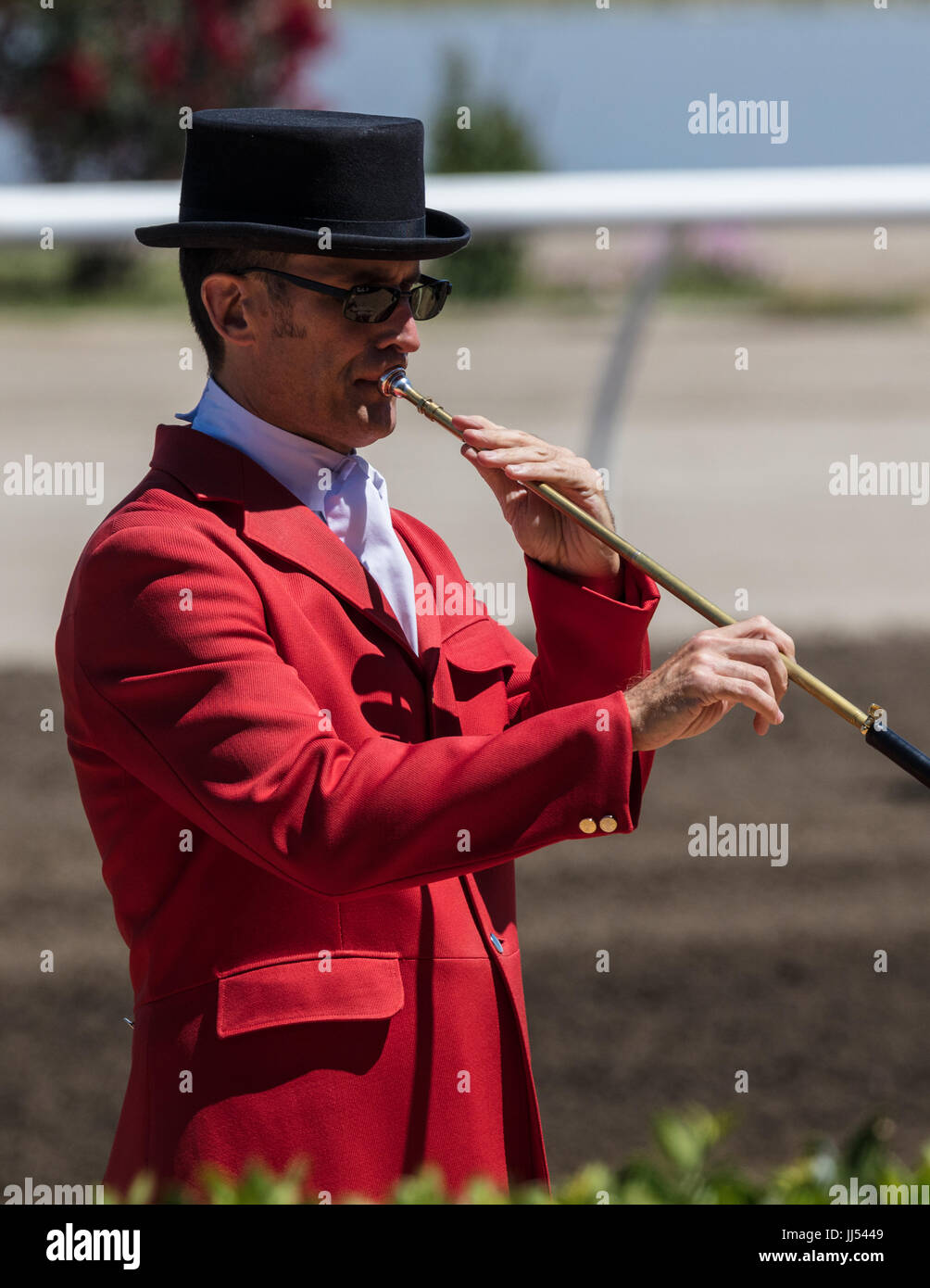 Bugler in top hat and coat plays Cal to the Post at the horse races in ...