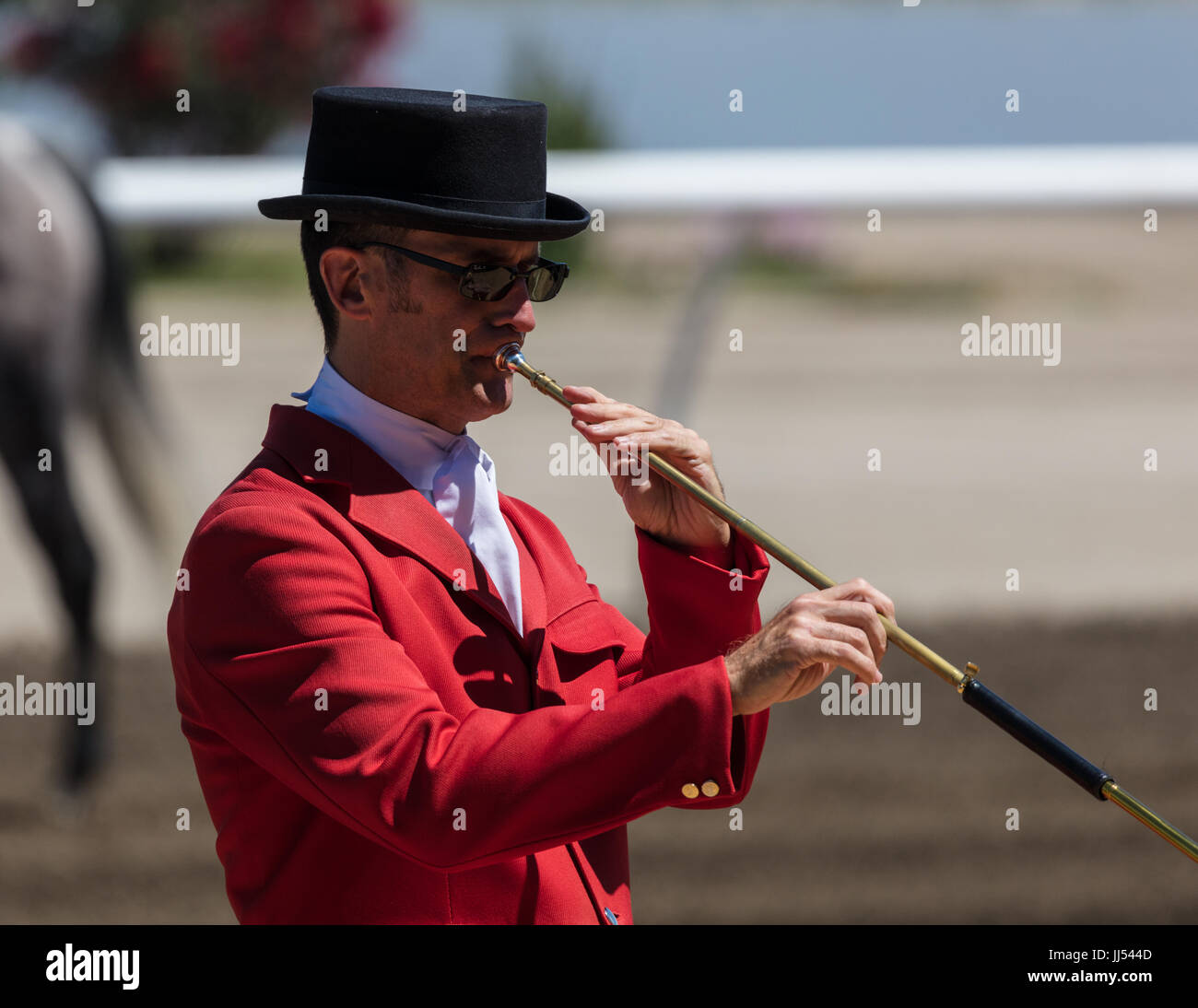 Bugler in top hat and coat plays Cal to the Post at the horse races in ...
