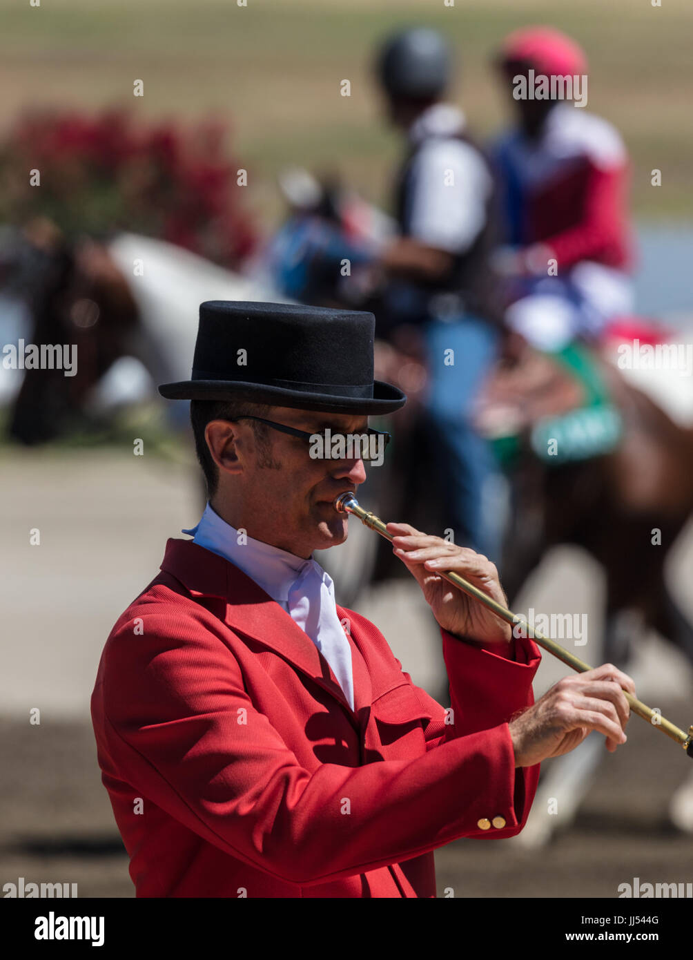 Bugler in top hat and coat plays Cal to the Post at the horse races in ...
