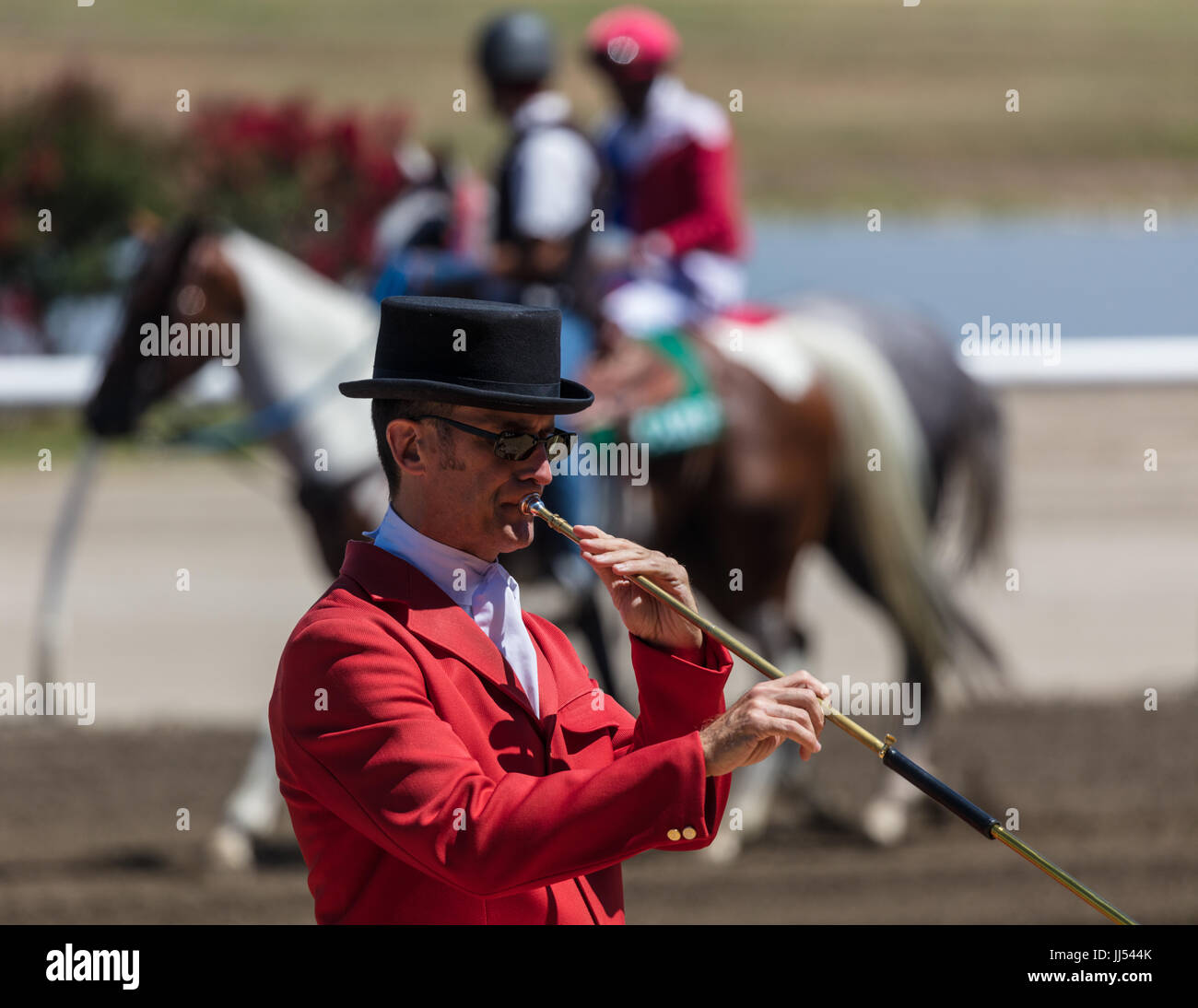 Bugler in top hat and coat plays Cal to the Post at the horse races in ...