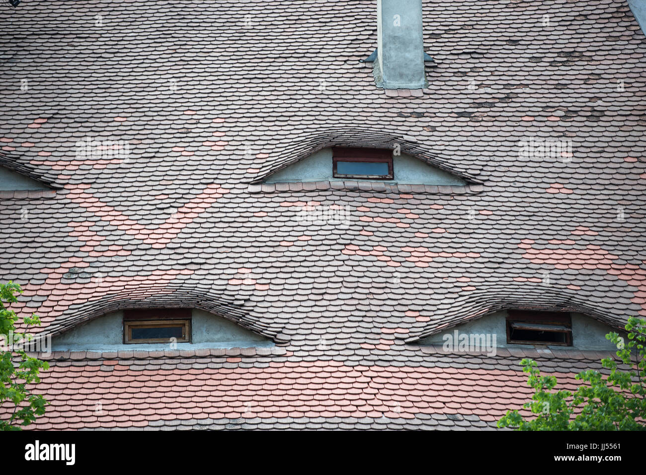 Eye-shaped windows on the tiled roofs of Sibiu, Transylvania, Romania ...