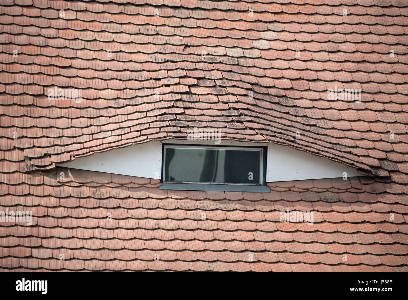 Eye-shaped window on the tiled roofs of Sibiu, Transylvania, Romania ...