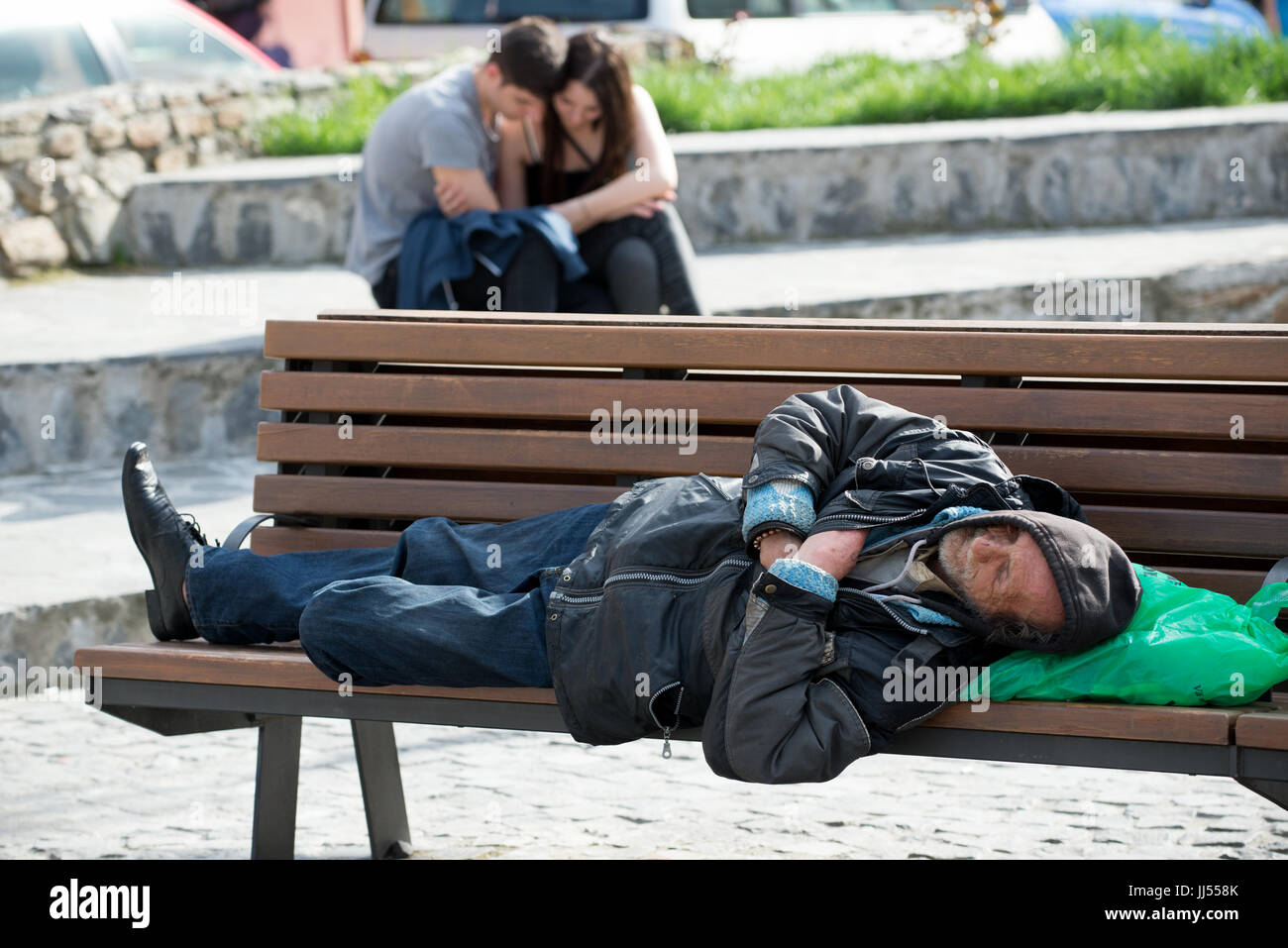 An homeless sleeping on a public bench in Sibiu, Transylvania, Romania ...