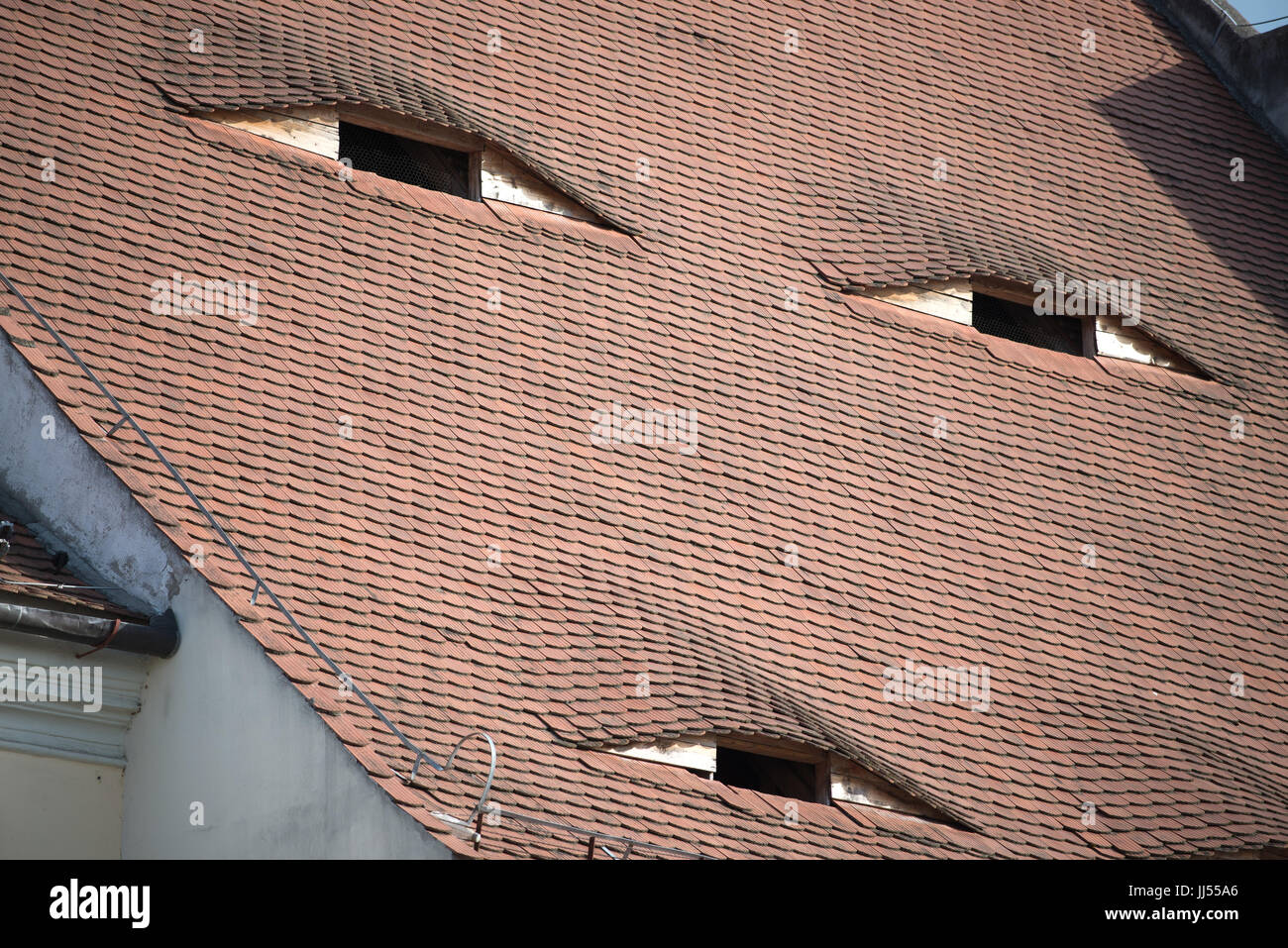 Eye-shaped windows on the tiled roofs of Sibiu, Transylvania, Romania ...
