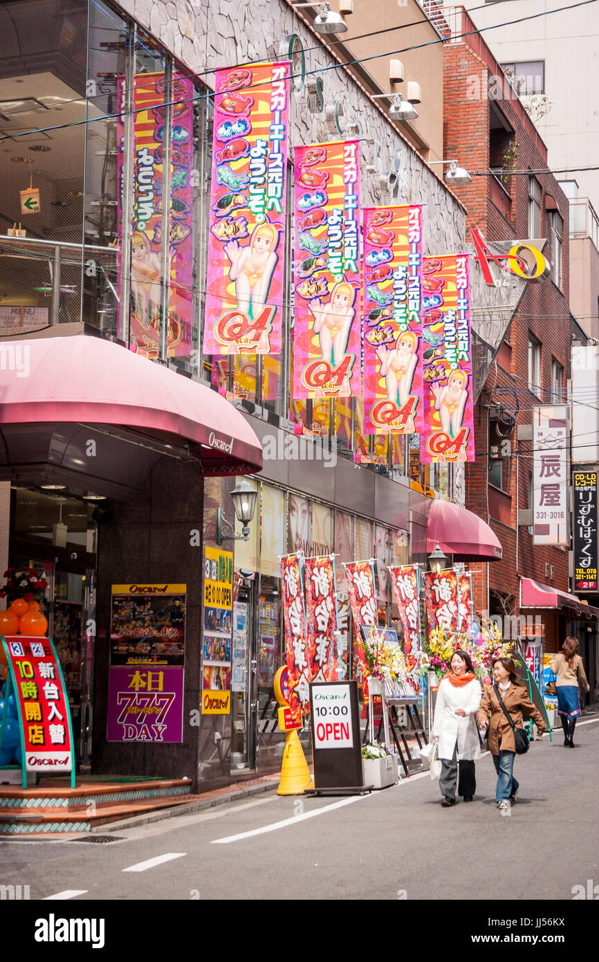 Japan, Kobe. Row of posters hanging on front of pachinko parlour ...
