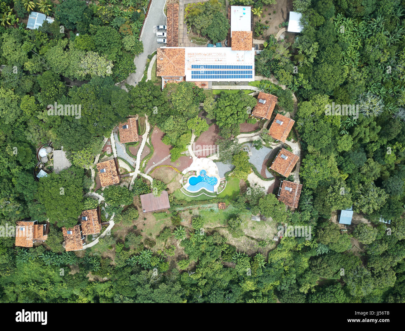Aerial view on houses with pool in middle. Houses in nature tree around ...