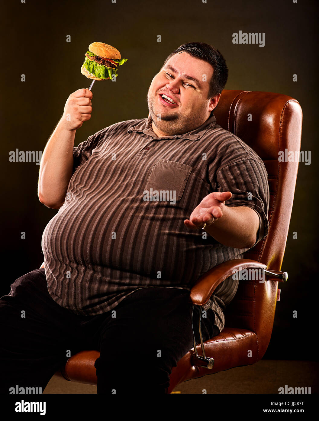 Fat man eating fast food hamberger. Breakfast for overweight person ...