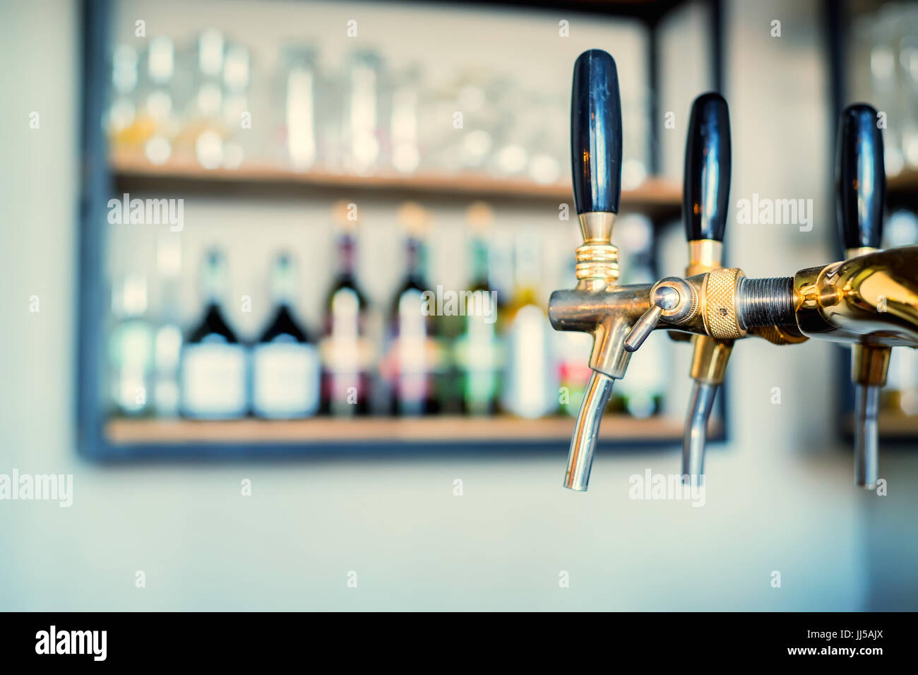 Chrome beer taps in modern bar Stock Photo - Alamy