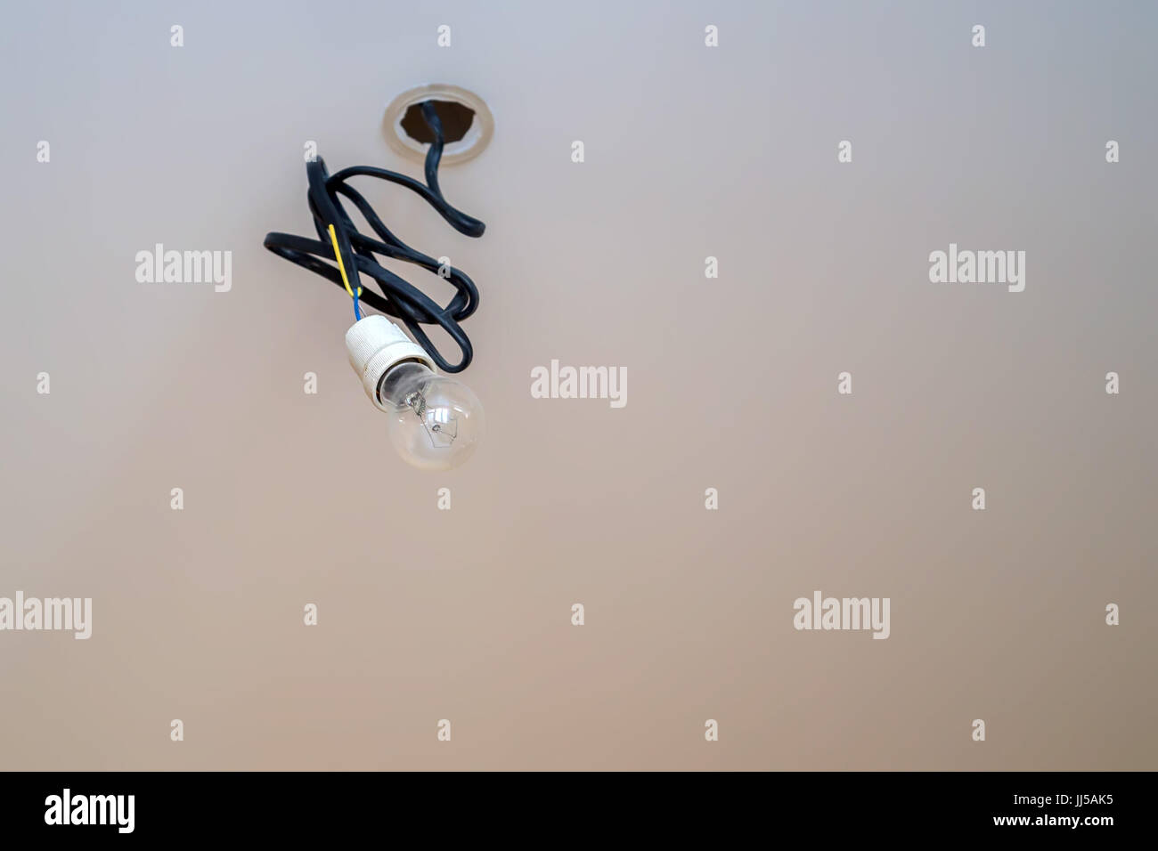 Close up light bulb hangs on the cable Stock Photo - Alamy
